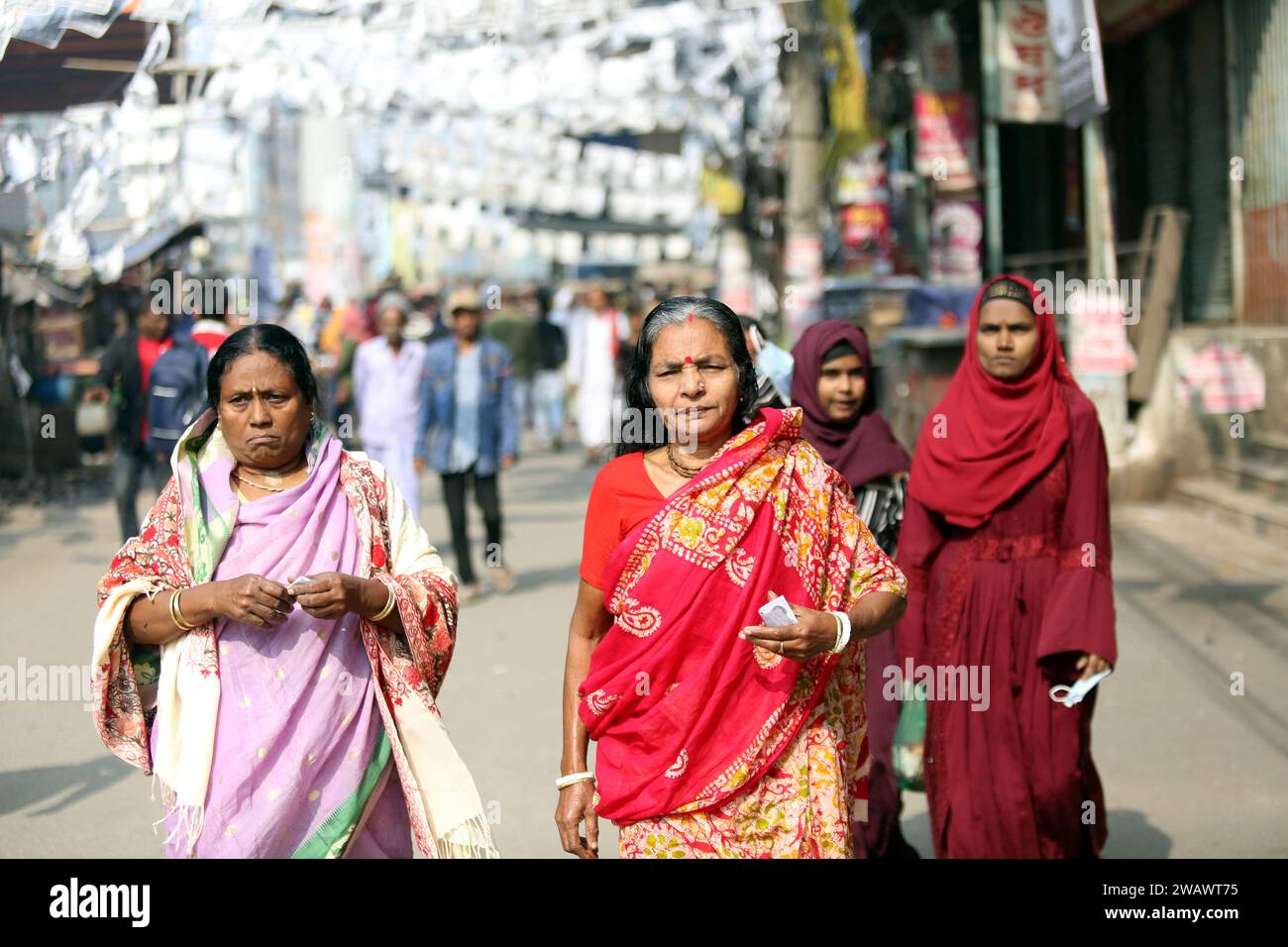 People arrive at a polling center to cast their votes for the 12th ...