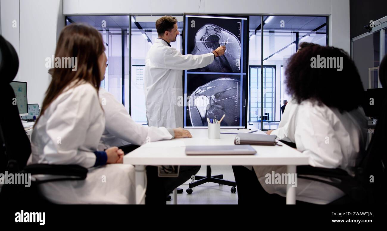 Diverse Doctors Team Looking At Shoulder MRT Scans Stock Photo - Alamy