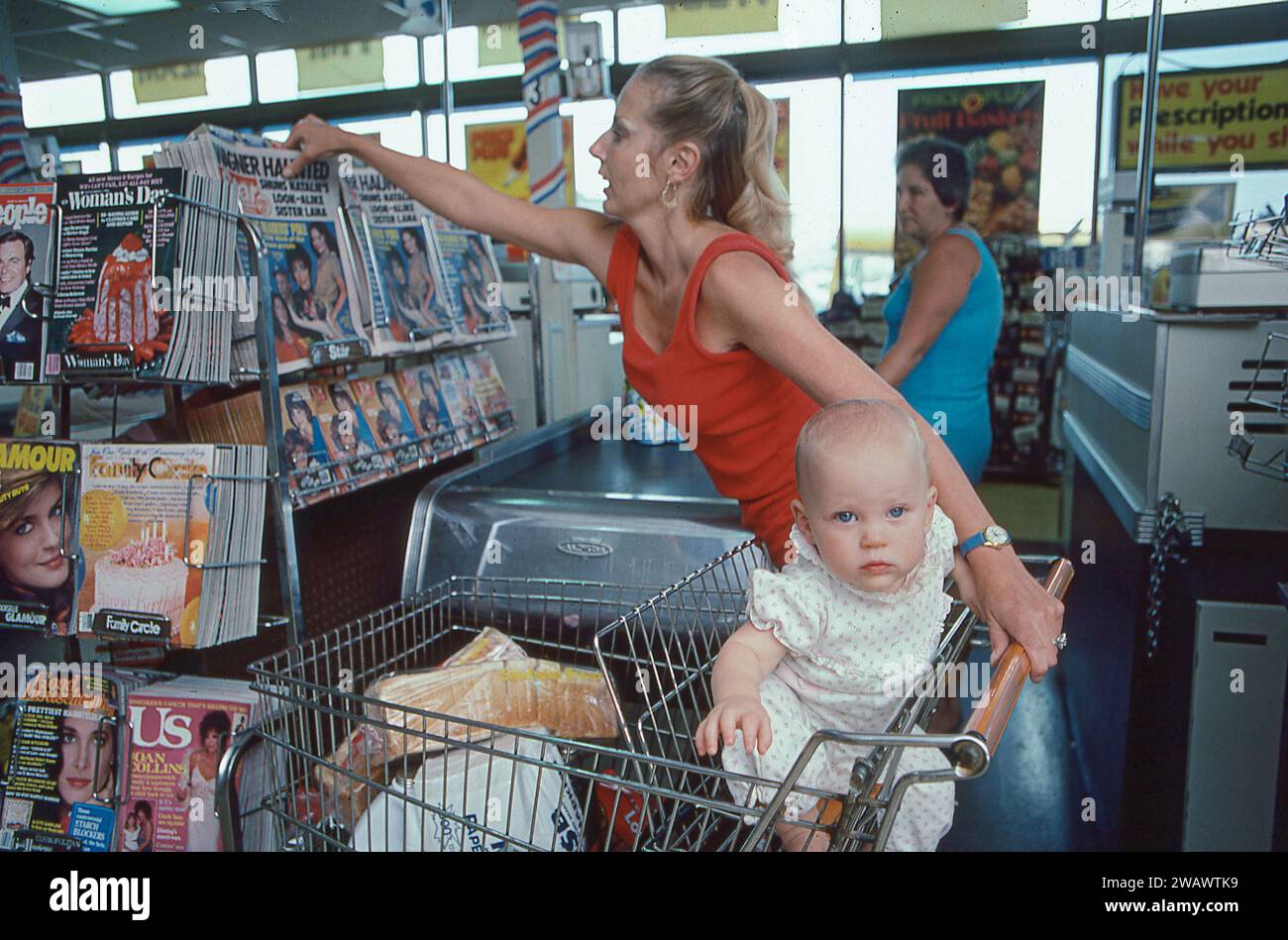 A mother reaches for a copy of the August 21, 1982 Star magazine while ...