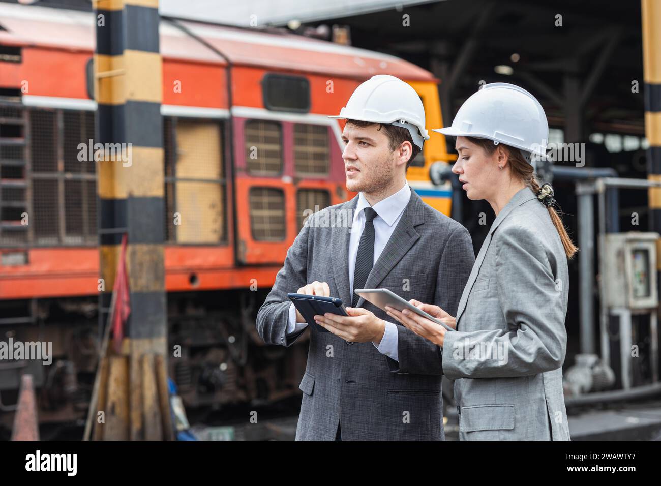 business man and woman standing together talking in heavy industry ...