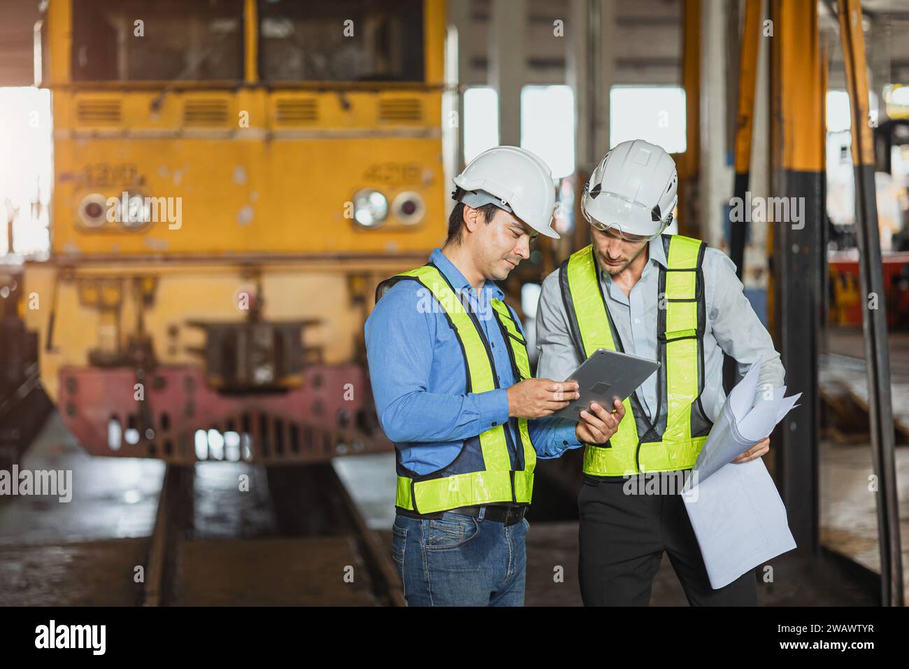 Engineer team work service maintenance diesel train at railway depot ...
