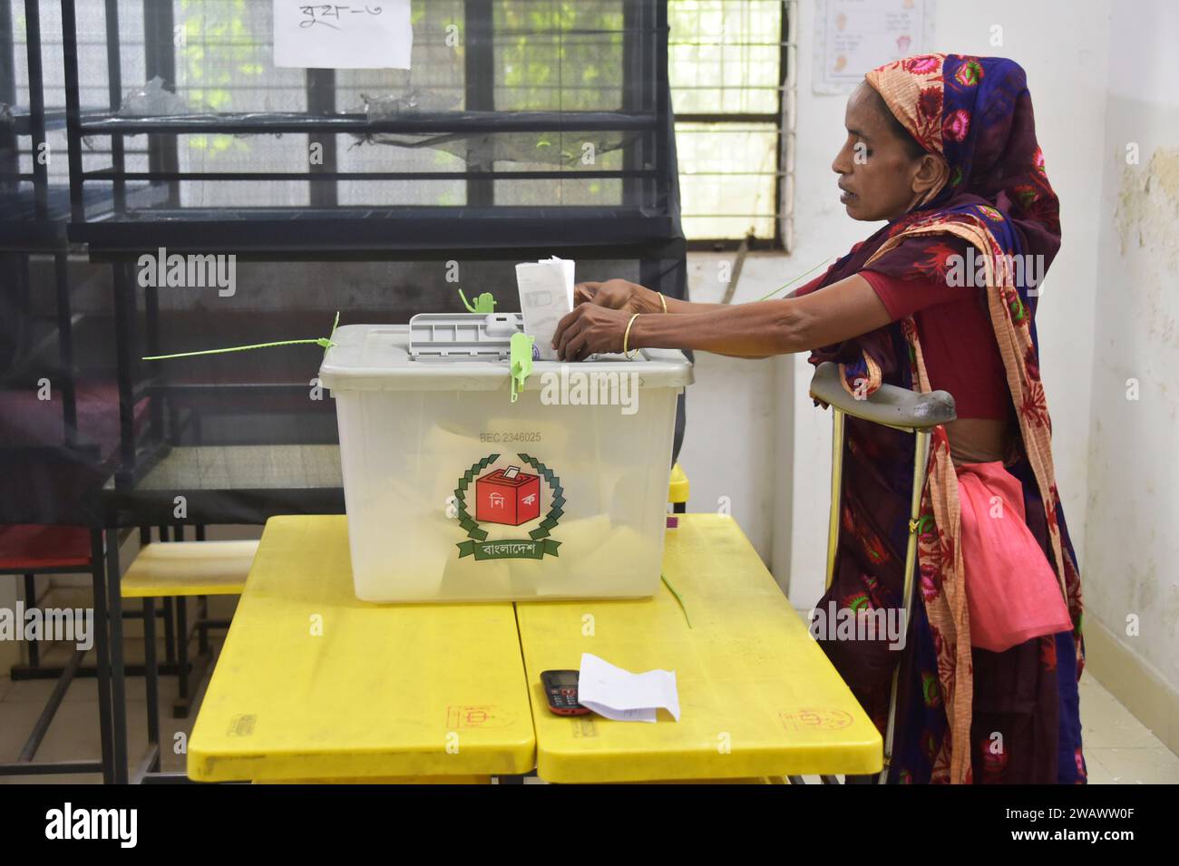 Dhaka. 7th Jan, 2024. A woman casts her ballot at a polling station in ...