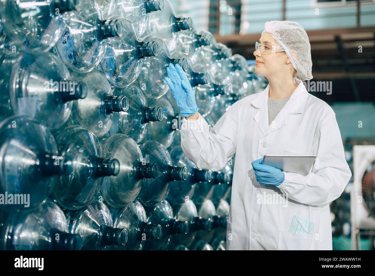 women worker working in drinking water plant factory checking count ...