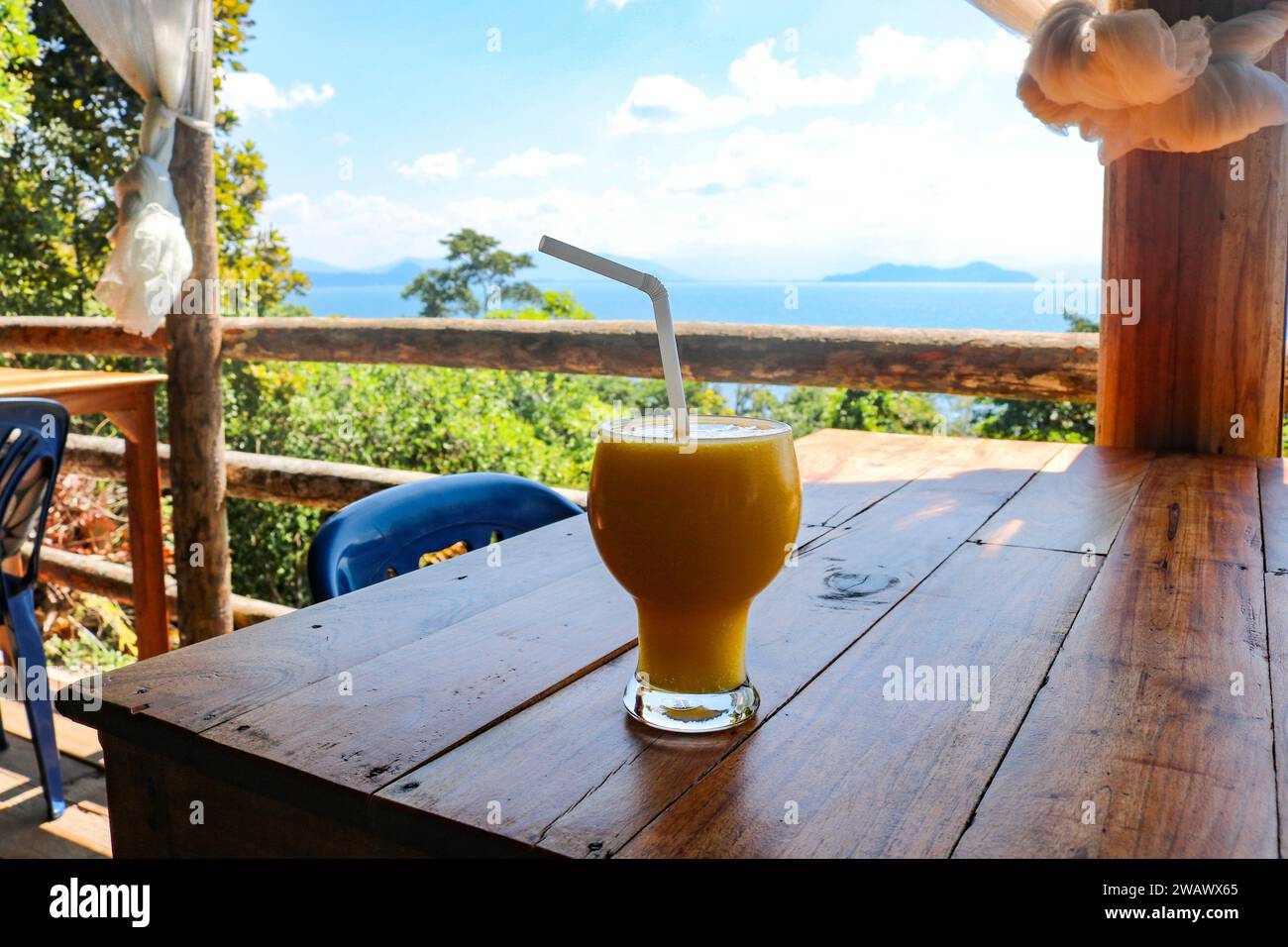 Fruit smoothie in a cafe overlooking the sea. The concept of relaxation ...
