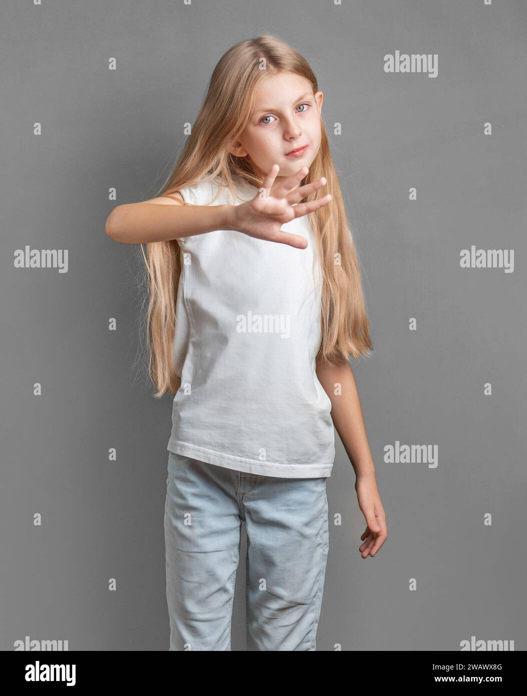 A little child girl showing a sign of protest or refusal with her hand ...