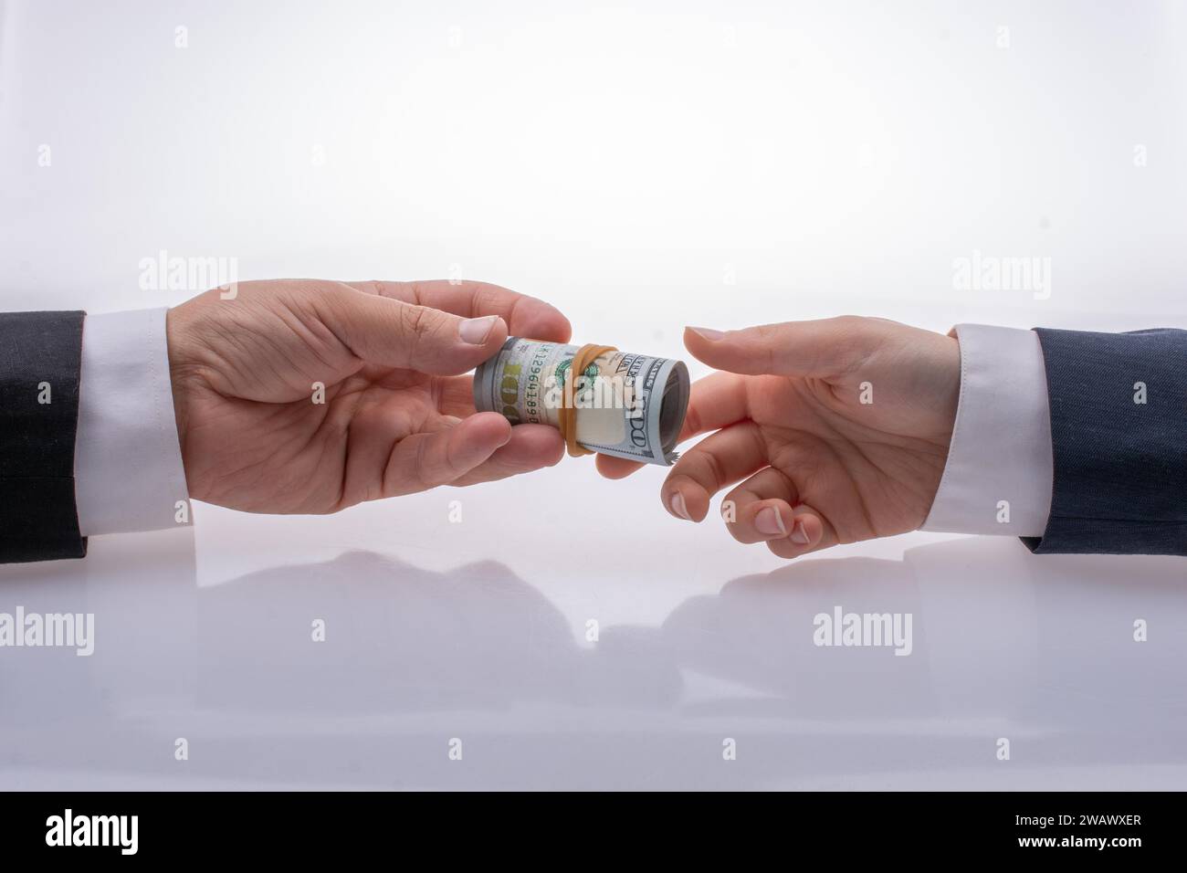 Businessman giving and receiving US dollar banknote money Stock Photo ...