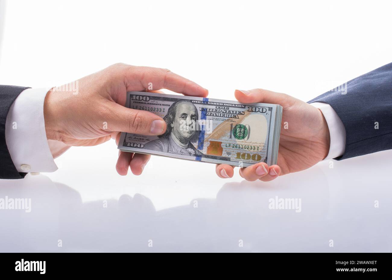 Businessman giving and receiving US dollar banknote money Stock Photo ...