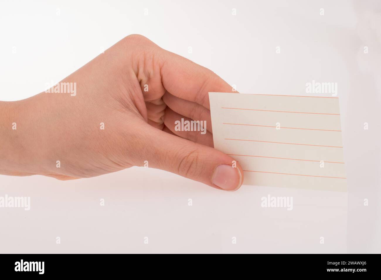 Hand holding a piece of lined paper on a white background Stock Photo ...