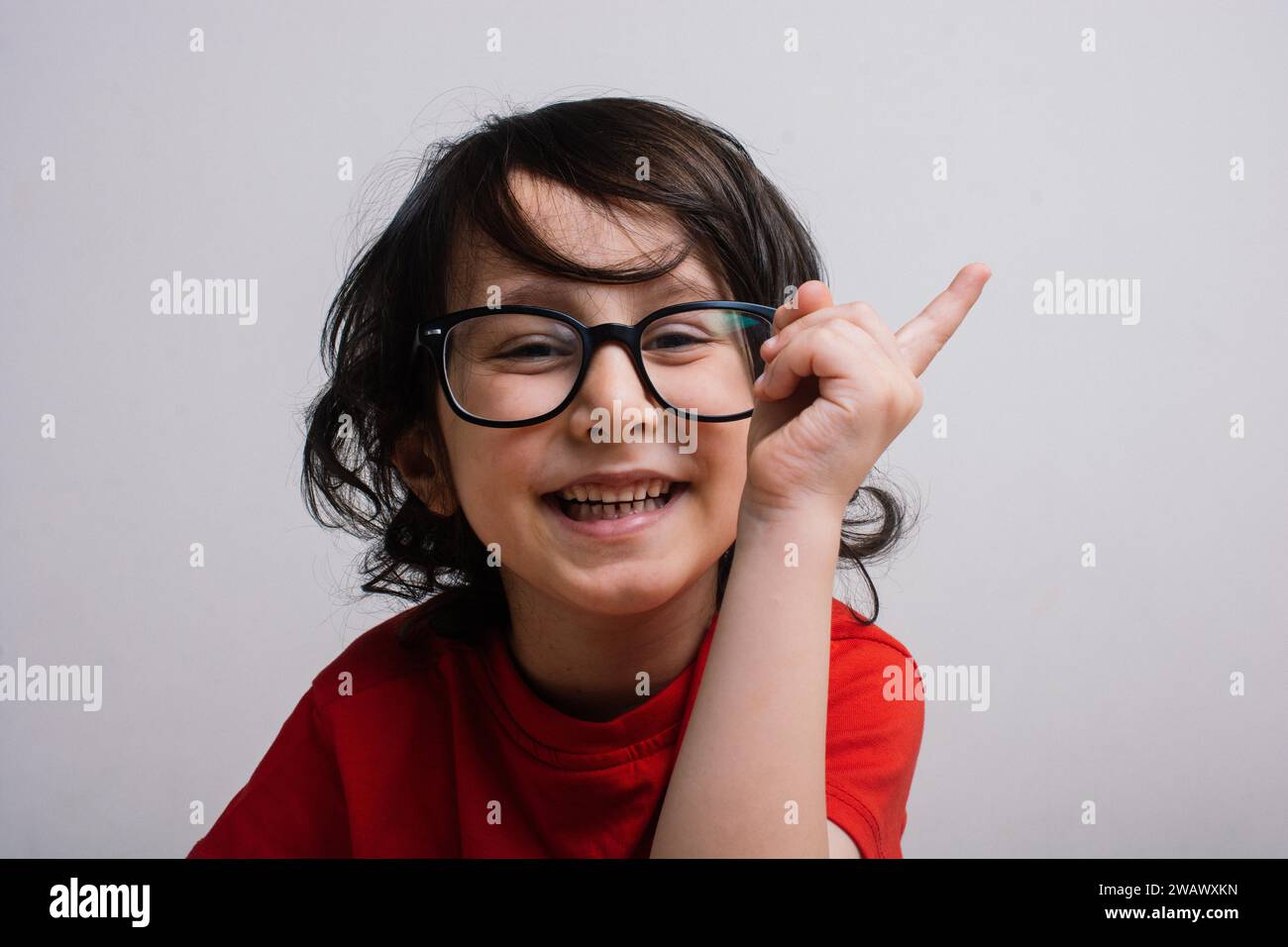 Smiling Little boy raising his hand isolated background Stock Photo - Alamy