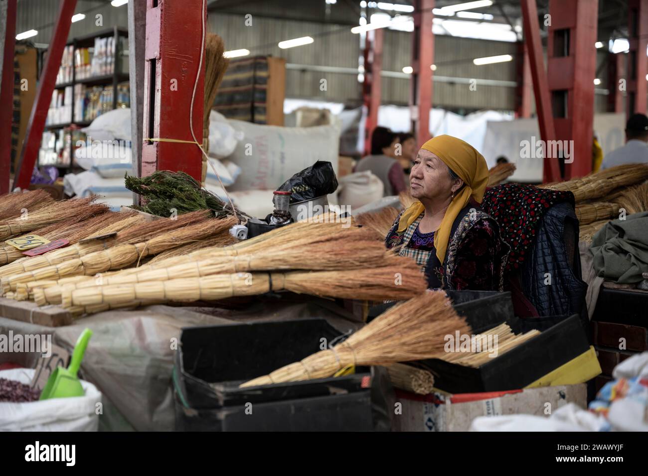 Vendor selling brooms, market stall at the Osh Bazaar, Bishkek ...