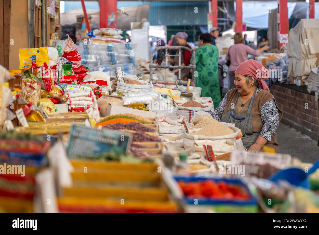 Traditional woman selling spices, flour and food, market stall at Osh ...