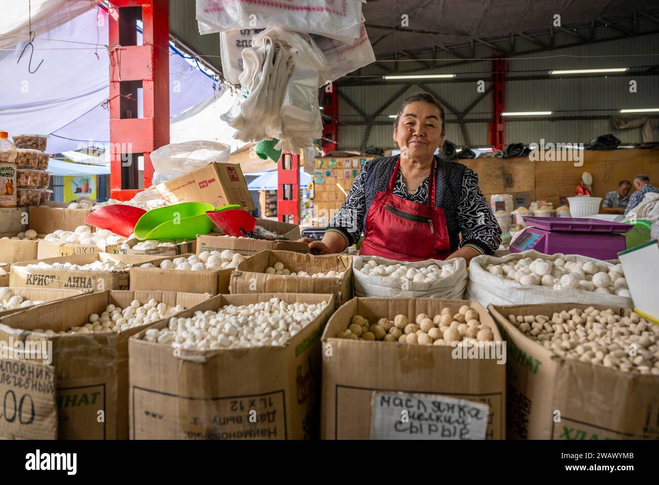 Traditional woman selling food, market stall at Osh Bazaar, Bishkek ...