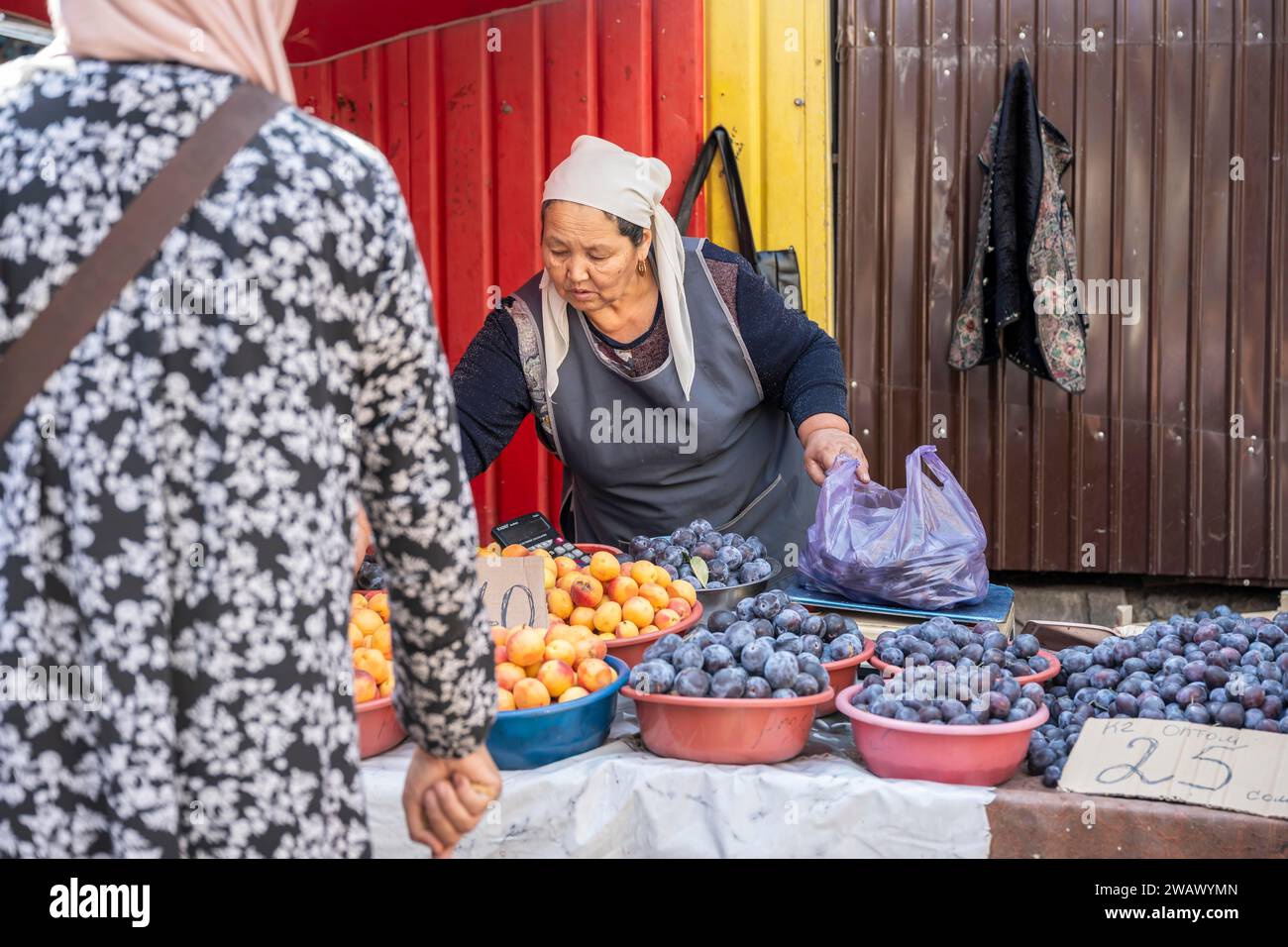 Fruit stall, woman selling fruit at the Osh bazaar, Bishkek, Kyrgyzstan ...