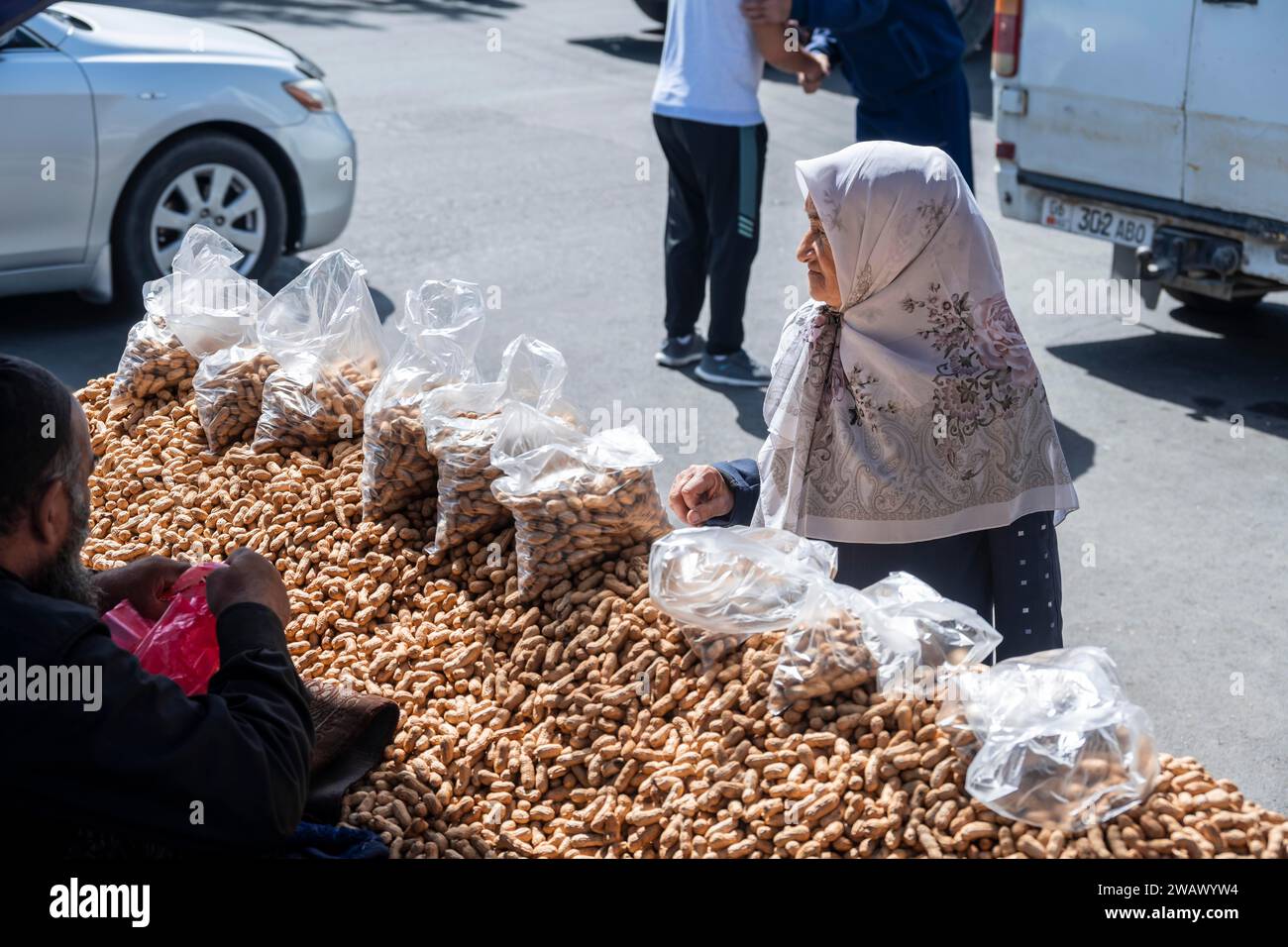 Vendor selling peanuts at a market stall, Uzgen BazaarOesgoen, Osh ...