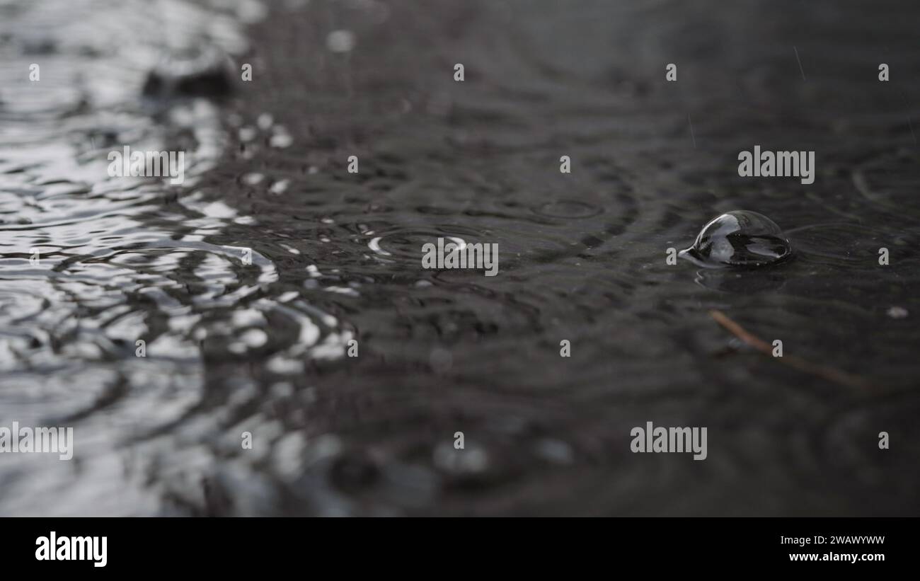 Rain puddles on street raindrops hi-res stock photography and images ...