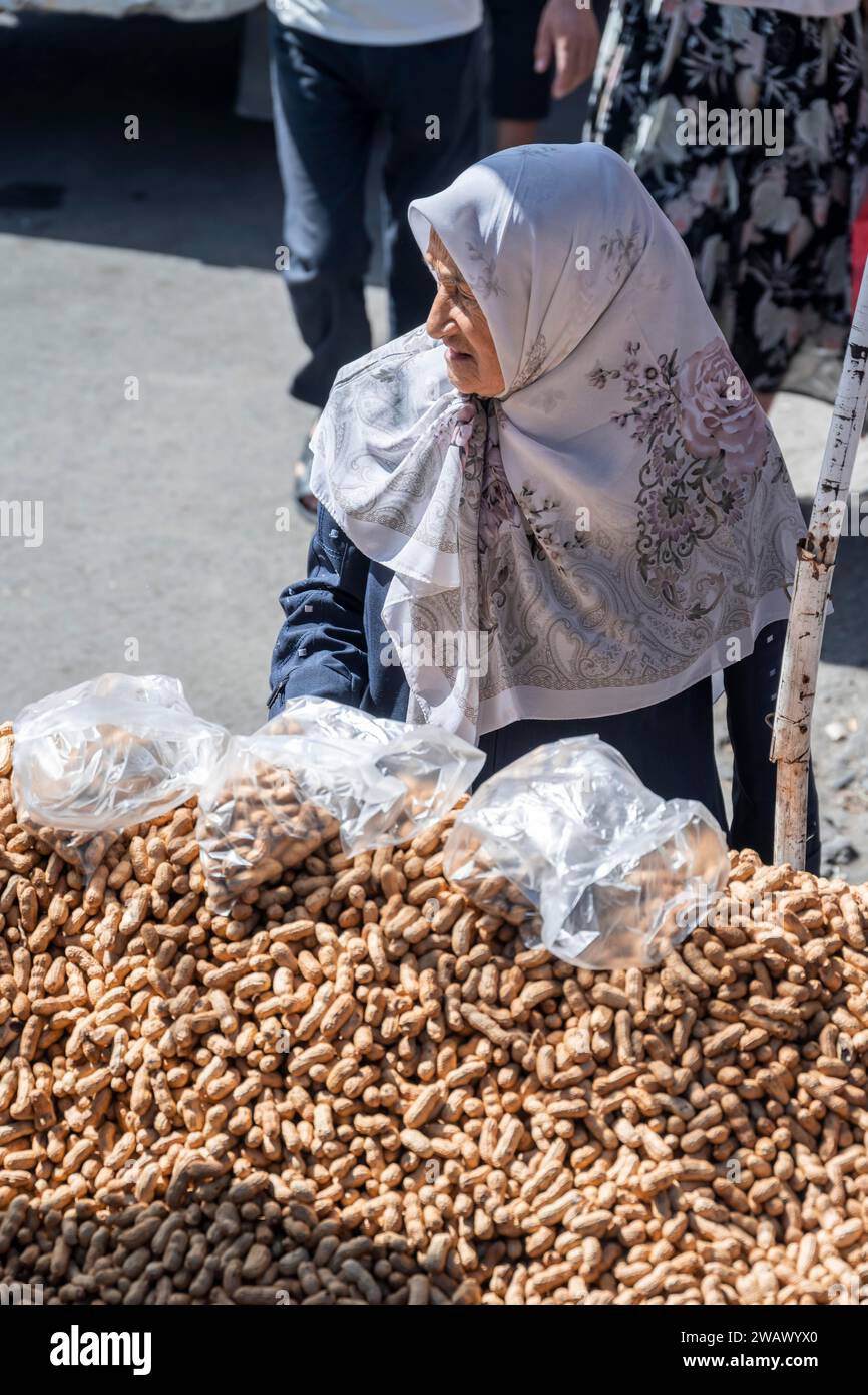 Vendor selling peanuts at a market stall, Uzgen Bazaar, Oesgoen, Osh ...