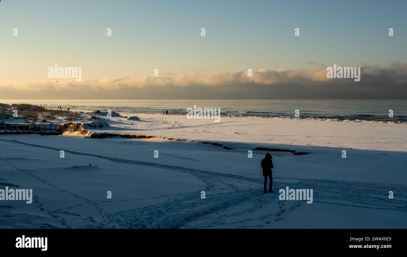 Golden hour unveils a mesmerizing duet: snow-draped coast and the ...