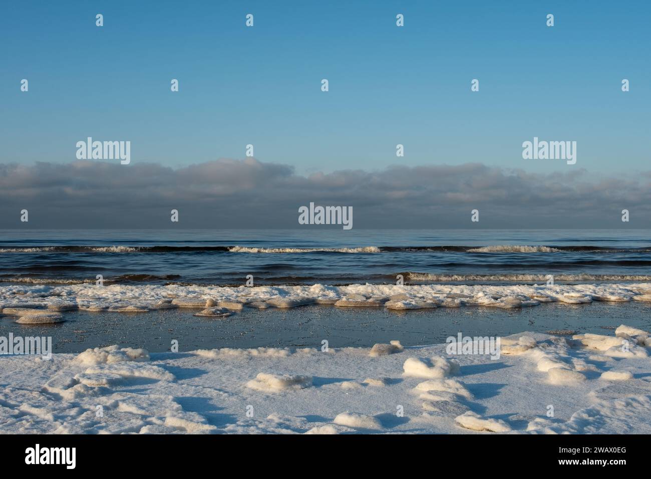 Winter's story unfolds in hues of gold along the icy embrace of the ...
