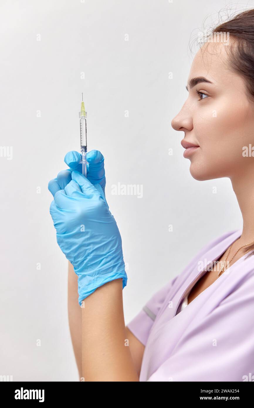 woman doctor in blue gloves with syringe for injection Stock Photo - Alamy