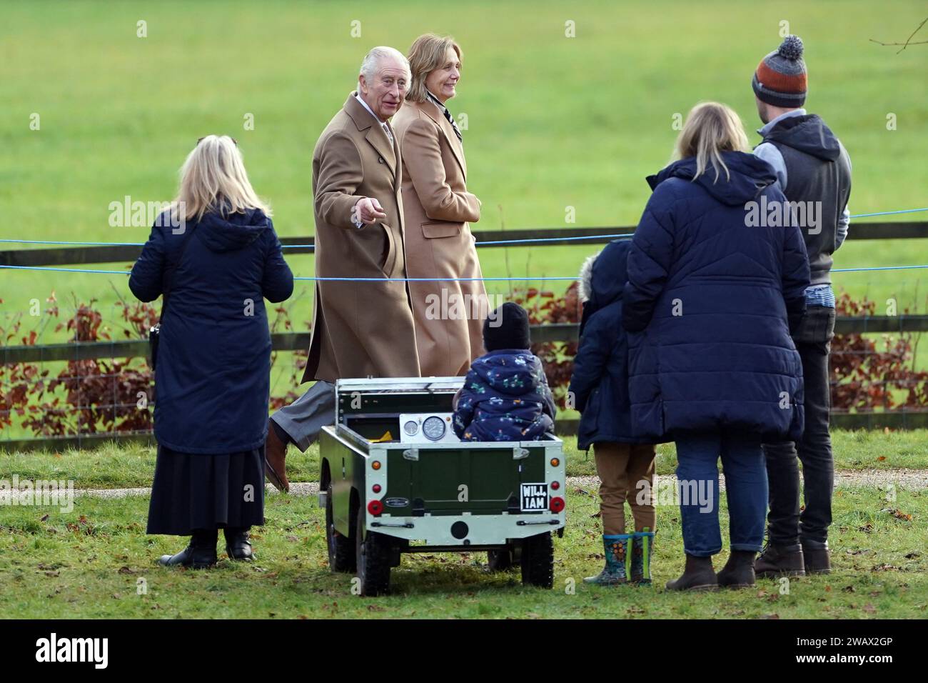 King Charles III talks to Simon and Georgina Ward and their sons ...