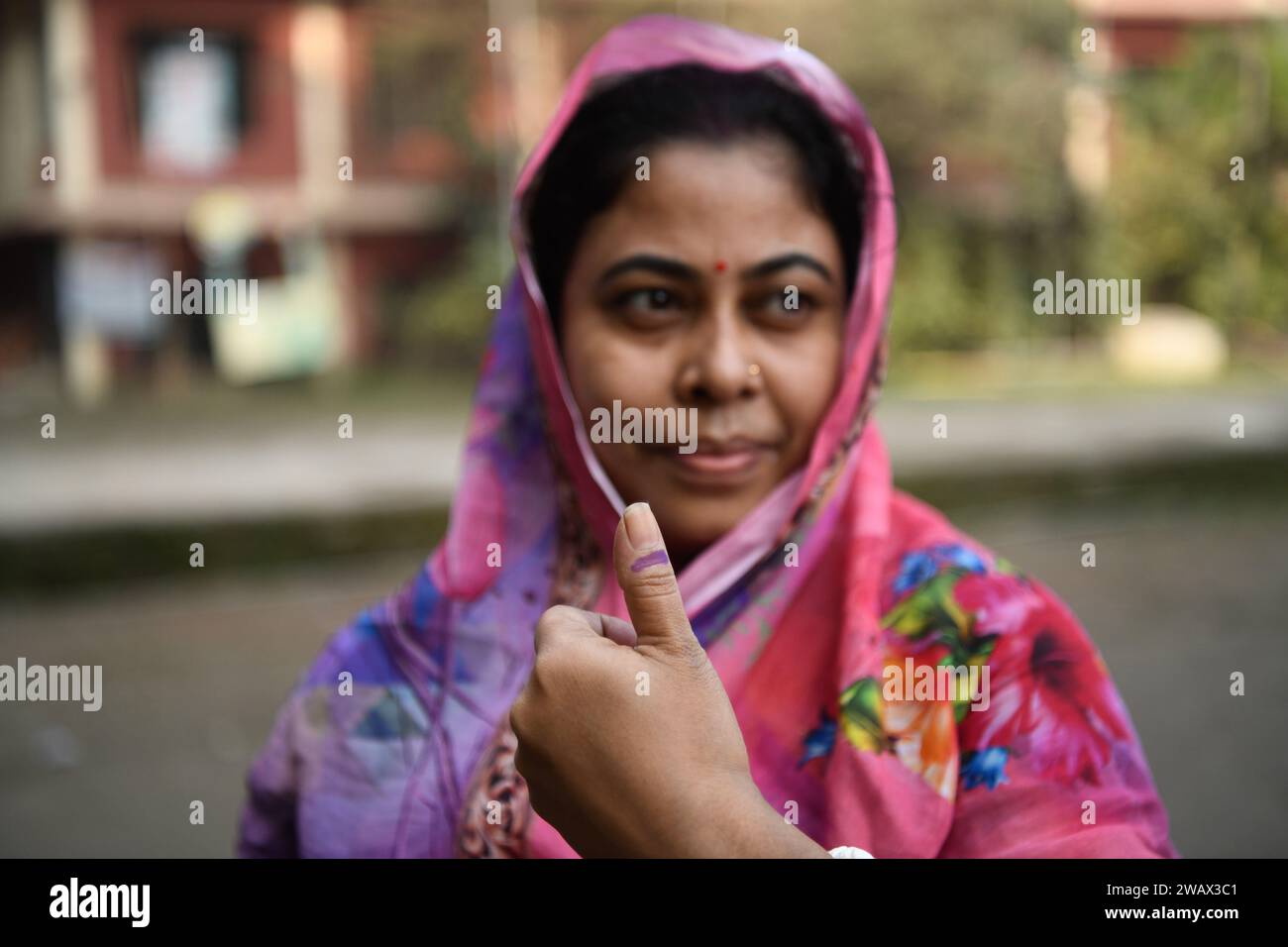 Dhaka, Bangladesh. 07th Jan, 2024. A woman shows her inked finger after ...
