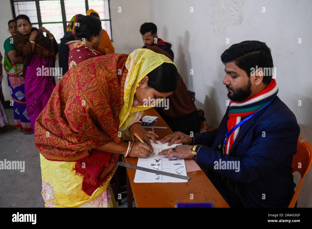 Dhaka, Bangladesh. 07th Jan, 2024. A woman signs to receive her ballot ...
