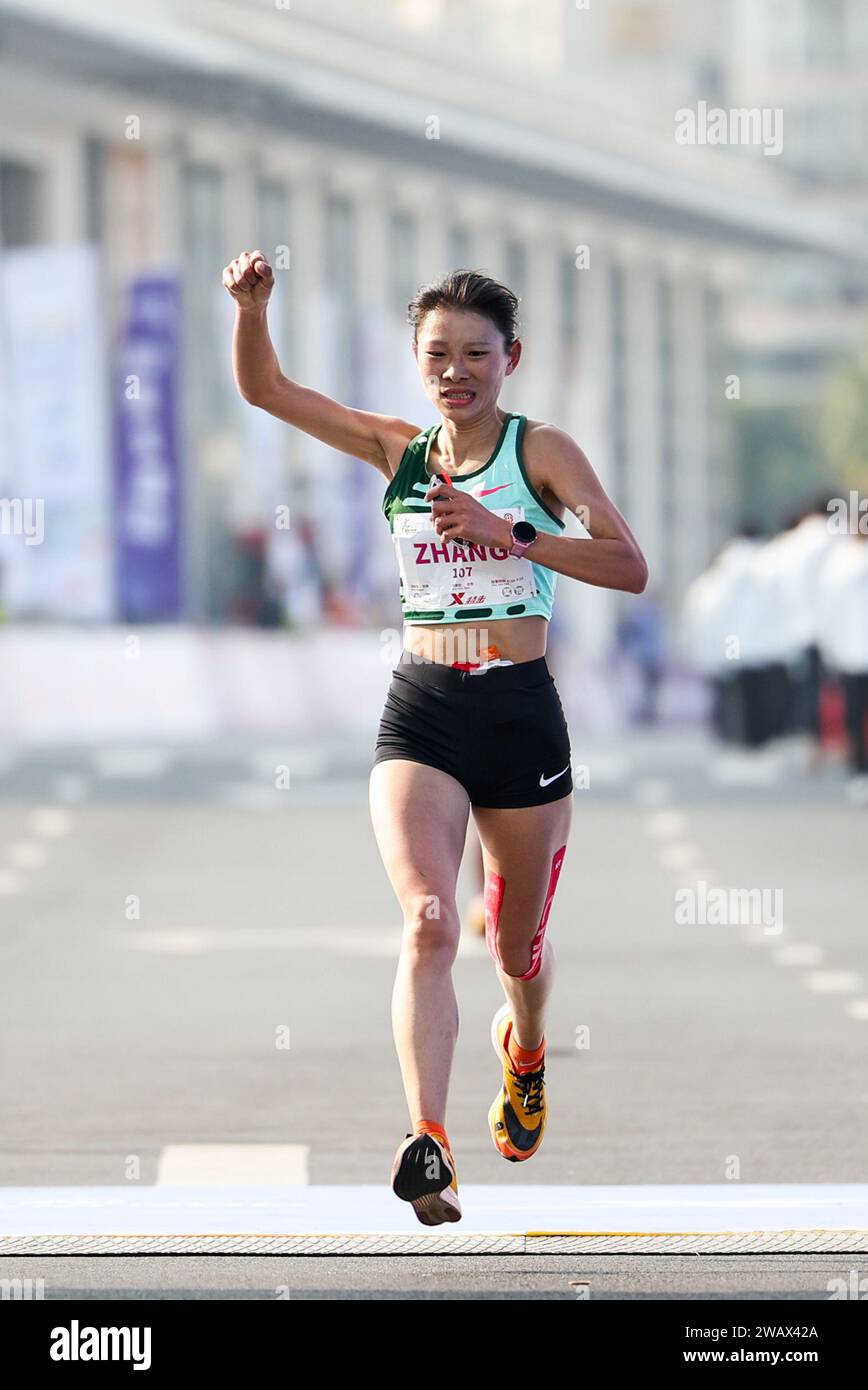 Xiamen. 7th Jan, 2024. Zhang Deshun of China crosses the finish line ...