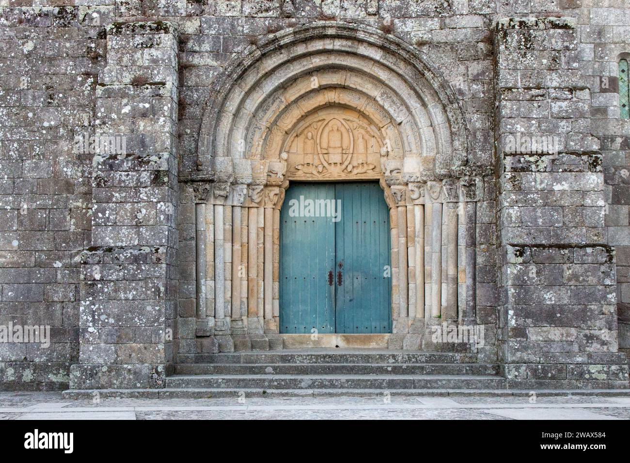 Closed entrance to the church with arch above the door. Old stone ...