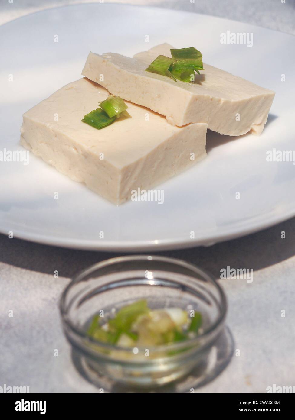 delicious Steam Tofu serve in white plate, with cutting leak leavese as ...