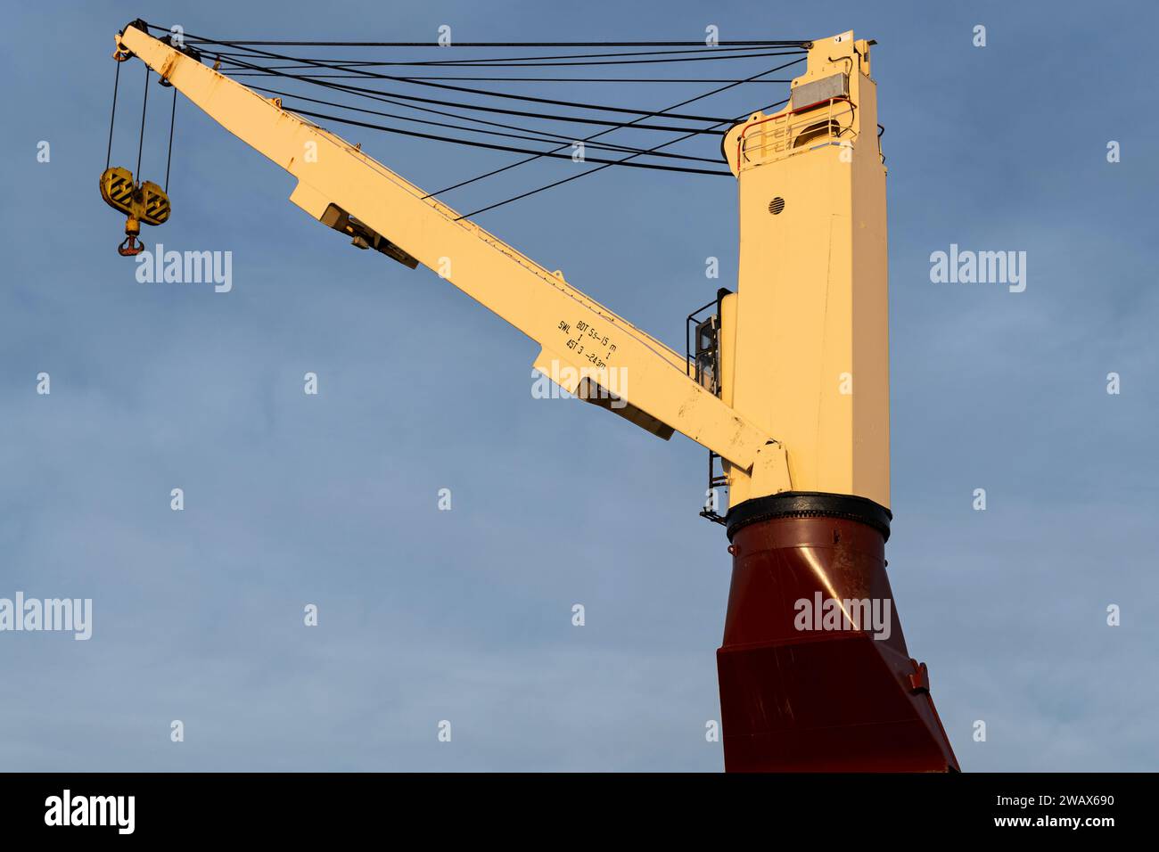 deck crane on board a ship against blue sky Stock Photo - Alamy