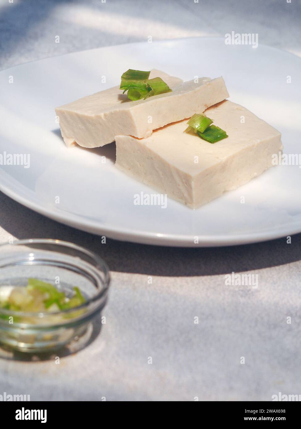 delicious Steam Tofu serve in white plate, with cutting leak leavese as ...