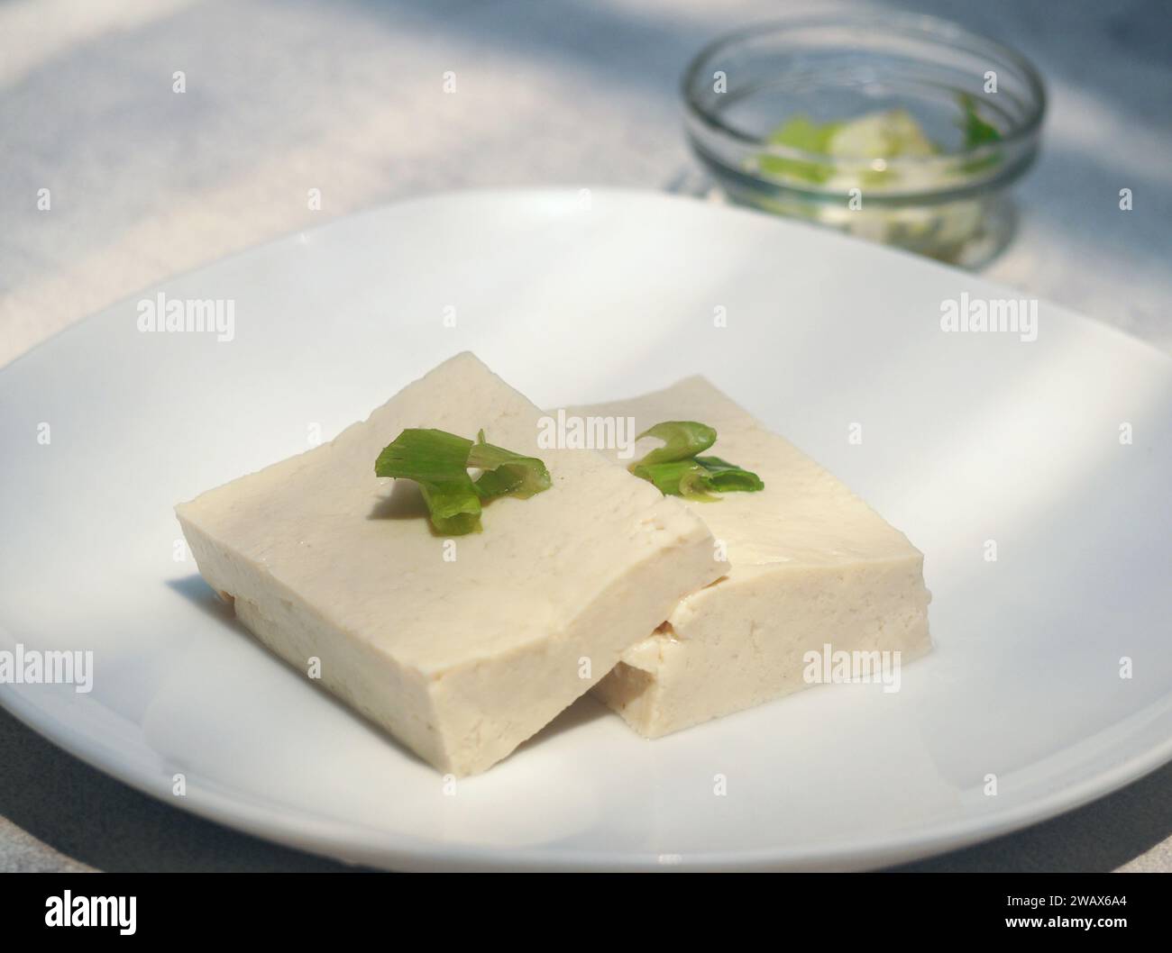 delicious Steam Tofu serve in white plate, with cutting leak leavese as ...