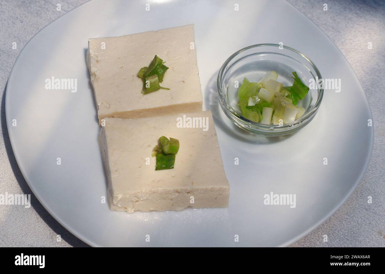 delicious Steam Tofu serve in white plate, with cutting leak leavese as ...