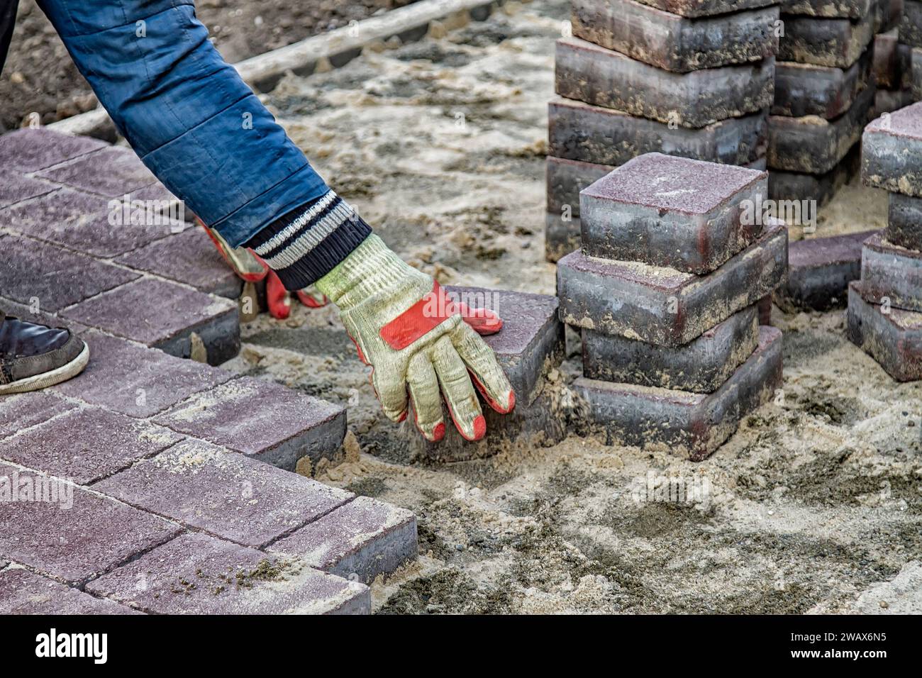 worker laying paving slabs on the street Stock Photo - Alamy
