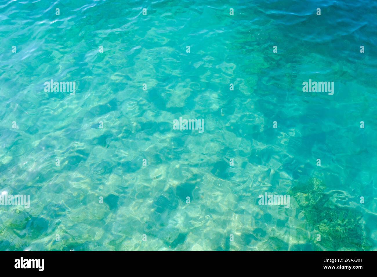 Clean transparent sea water, lake bottom and sand. Beautiful blue ...