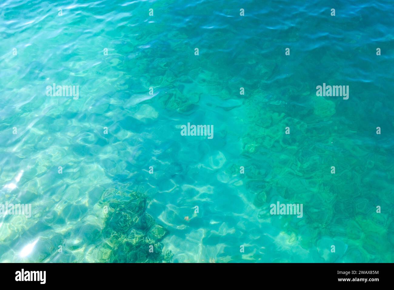 Clean transparent sea water, lake bottom and sand. Beautiful blue ...