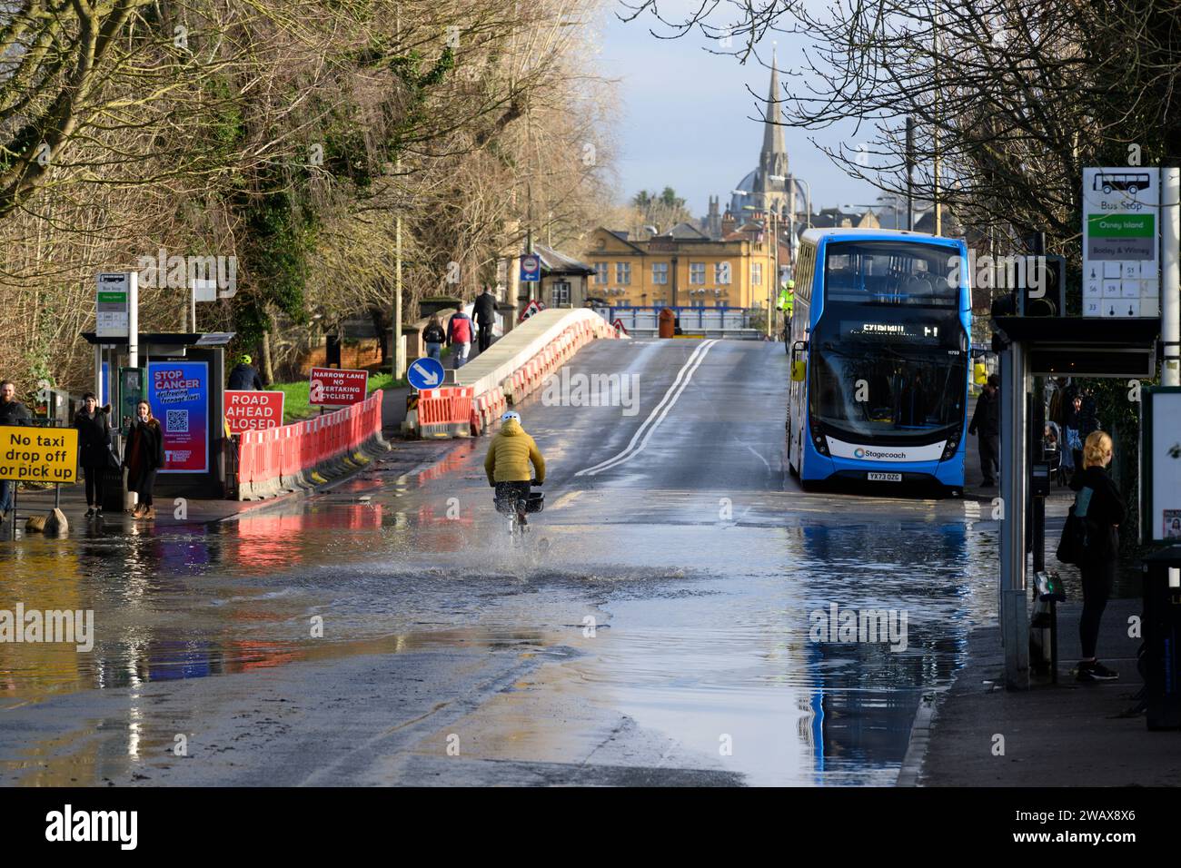 A cyclist riding through floodwater Botley Road, Oxford, Oxfordshire ...