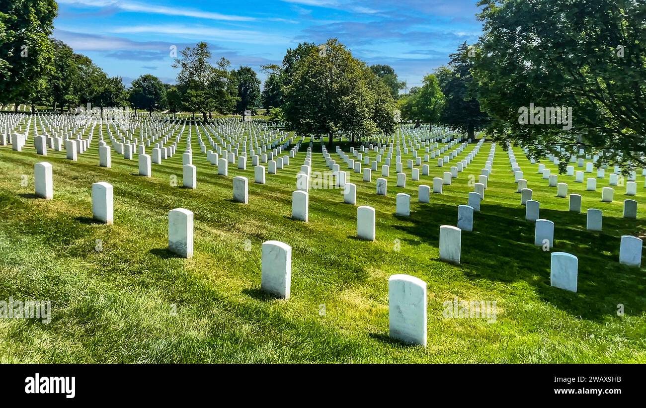 Walking on a sunny day with huge rows of white marble tombstones at ...
