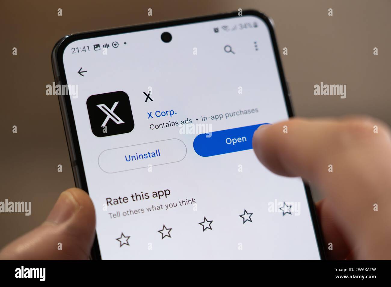 A finger pointing at the the X App (formerly twitter) installation page ...