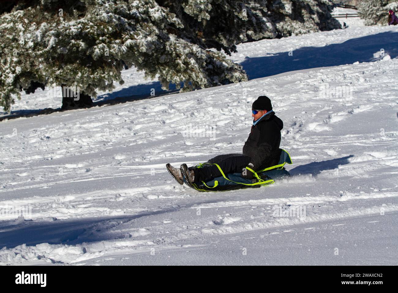 A person goes sledging in Puerto de Cotos, on January 7, 2024, in ...