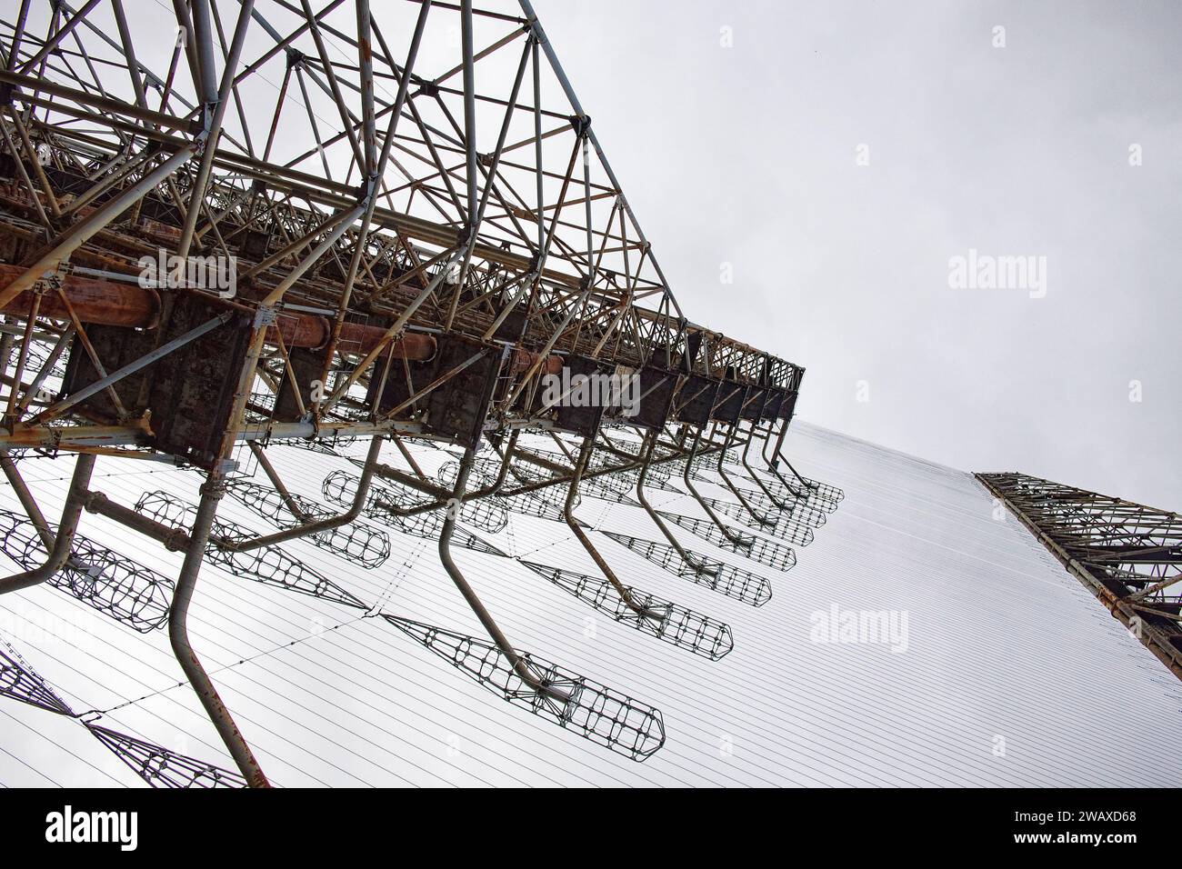 Rusted frameworks under a grey sky, entwined in dense wiring. Duga is a ...
