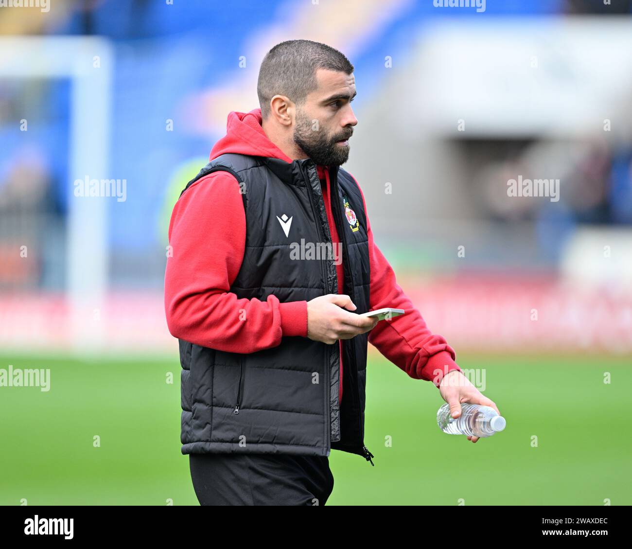 Elliot Lee of Wrexham inspects the pitch ahead of the match, during the ...