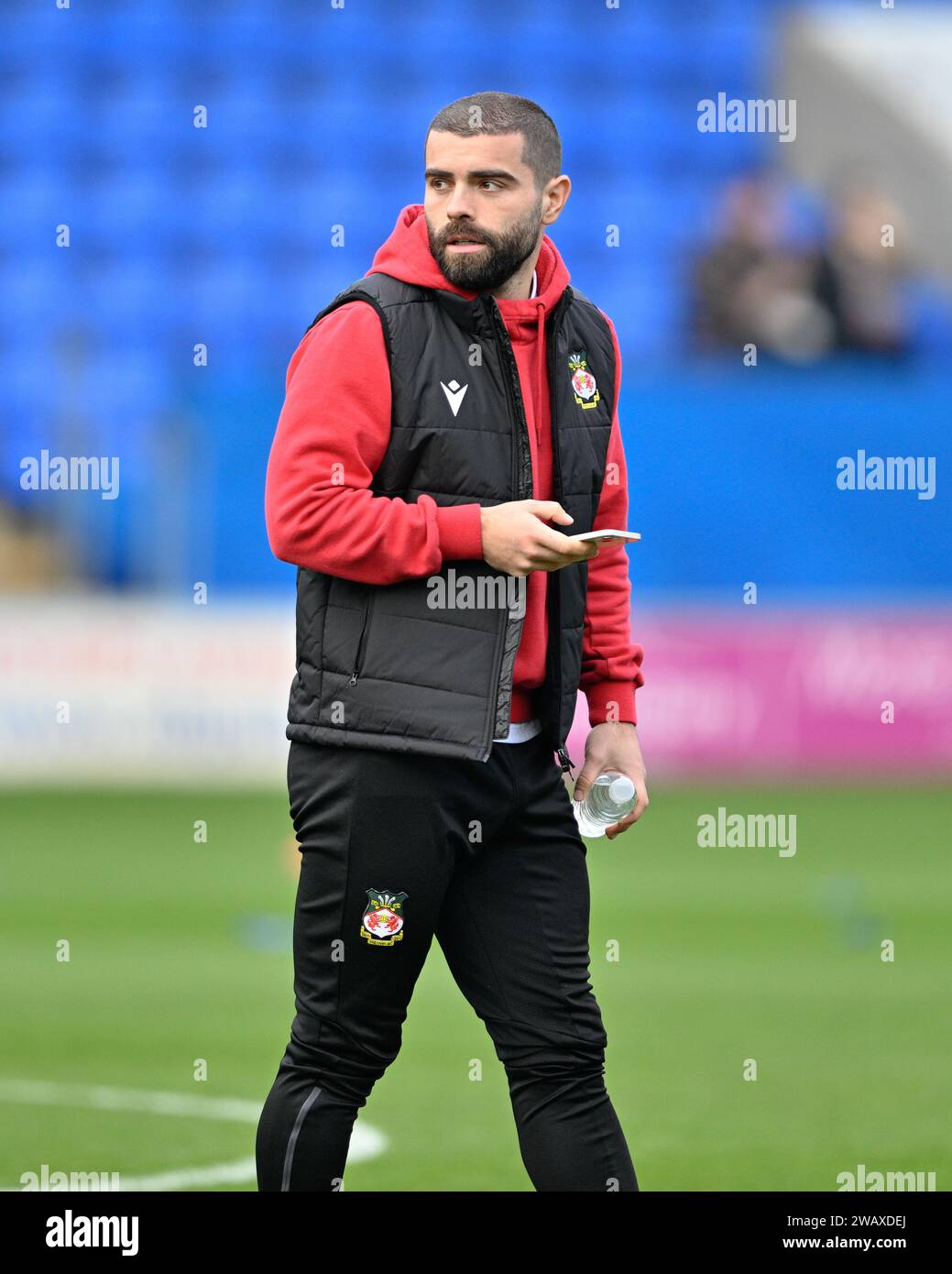 Elliot Lee of Wrexham inspects the pitch ahead of the match, during the ...