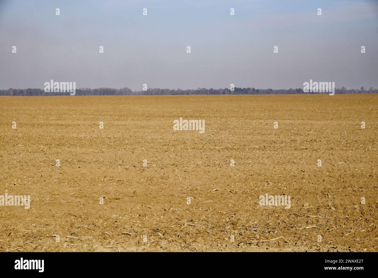 Brown soil in the foreground, horizon, and cloudy sky Stock Photo - Alamy