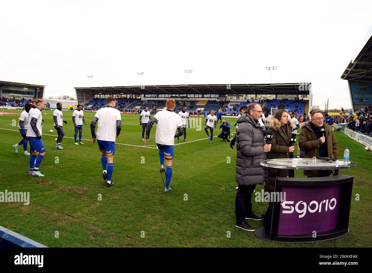 Shrewsbury Town players warm up on the pitch as S4C presenters preview ...