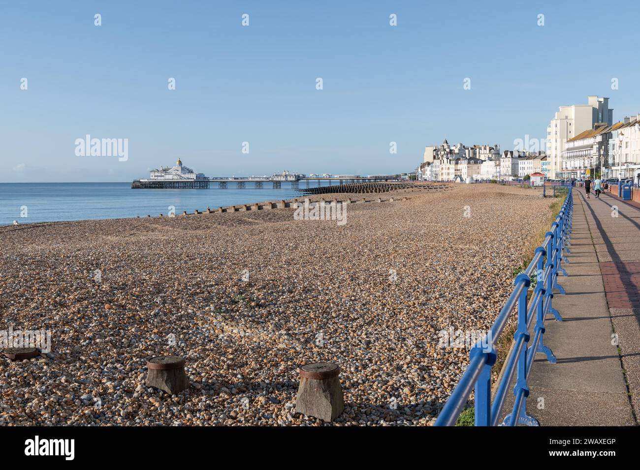 Eastbourne Pier, seafront and Beach with a clear blue sky and calm seas ...