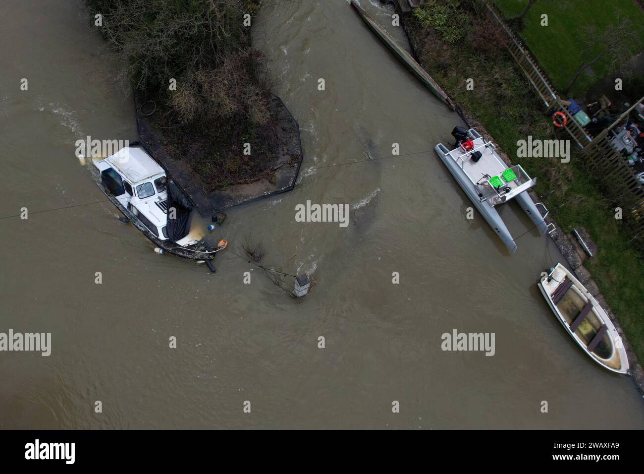A boat is half sunken in the floods of the river Thames in Oxford ...