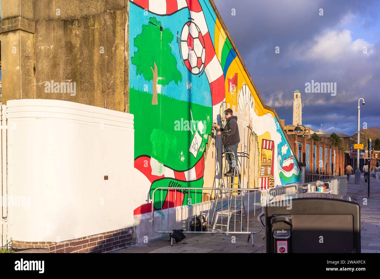 Southampton, UK. 6 January 2024.An artist is painting a colourful ...