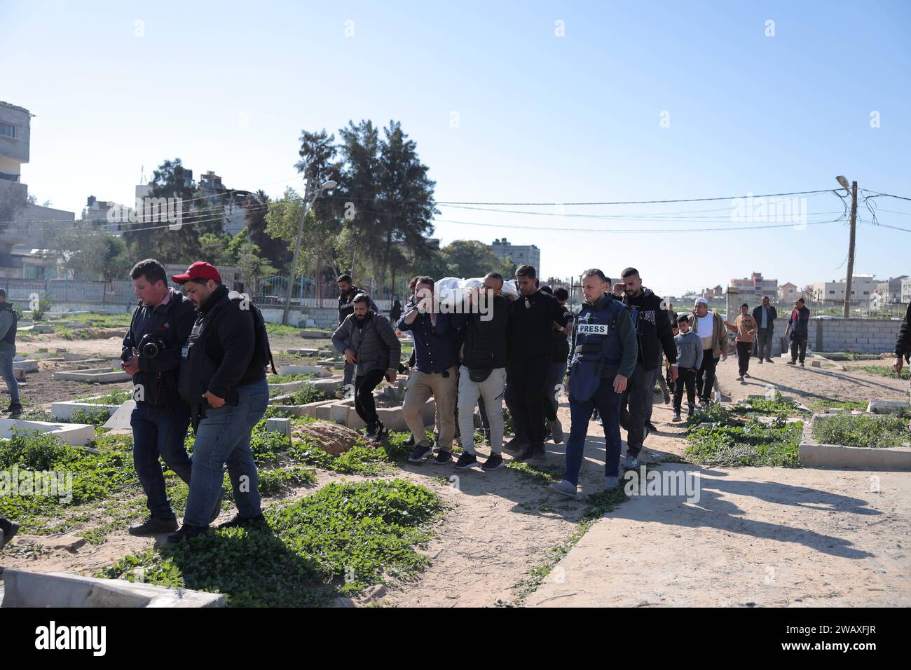 Palestinians attend in the funeral of Hamza Wael Dahdouh, a journalist ...