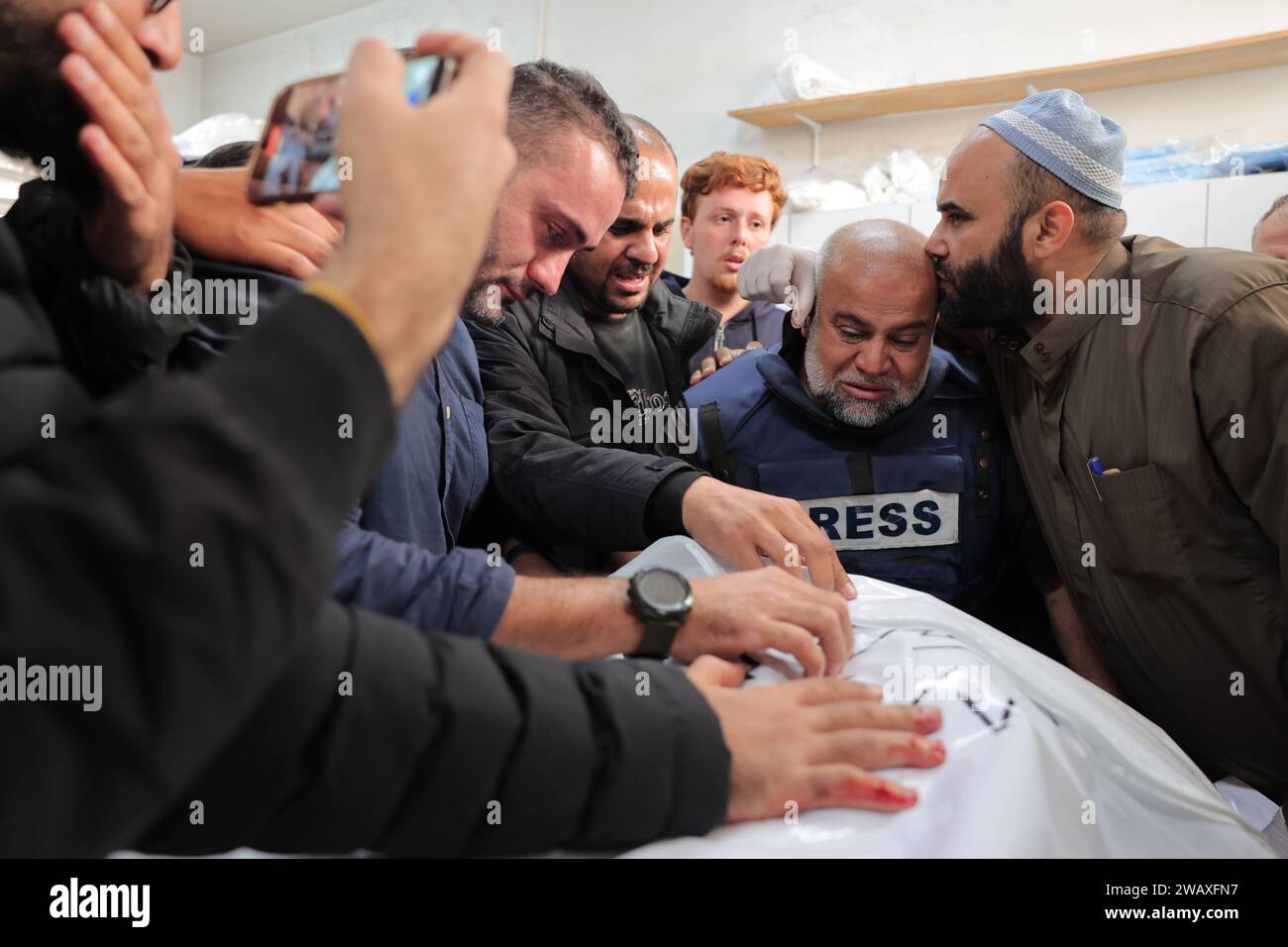 Palestinians attend in the funeral of Hamza Wael Dahdouh, a journalist ...